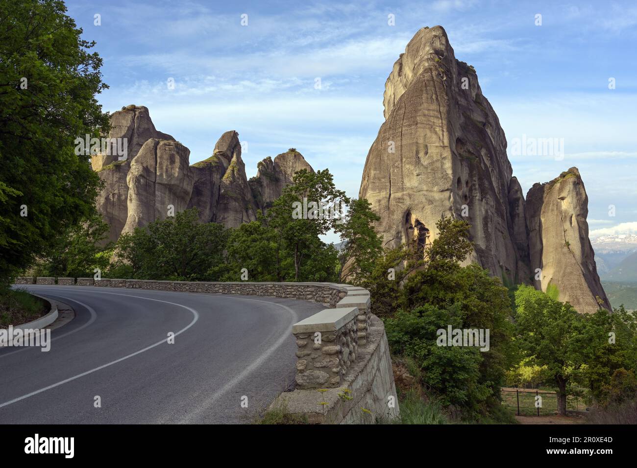 Curvy road between the mountains of Meteora with famous monasteries ...