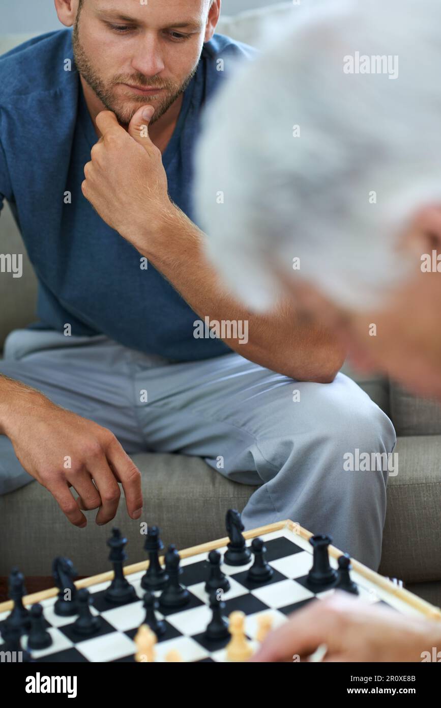 Dads got some interesting chess moves. a father and son playing a game ...