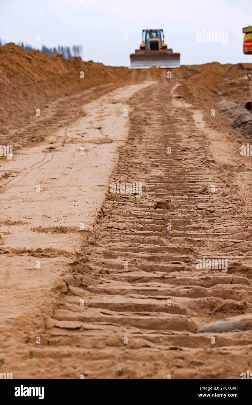 Sand subbase and bulldozer tracks prints. Road construction site ...