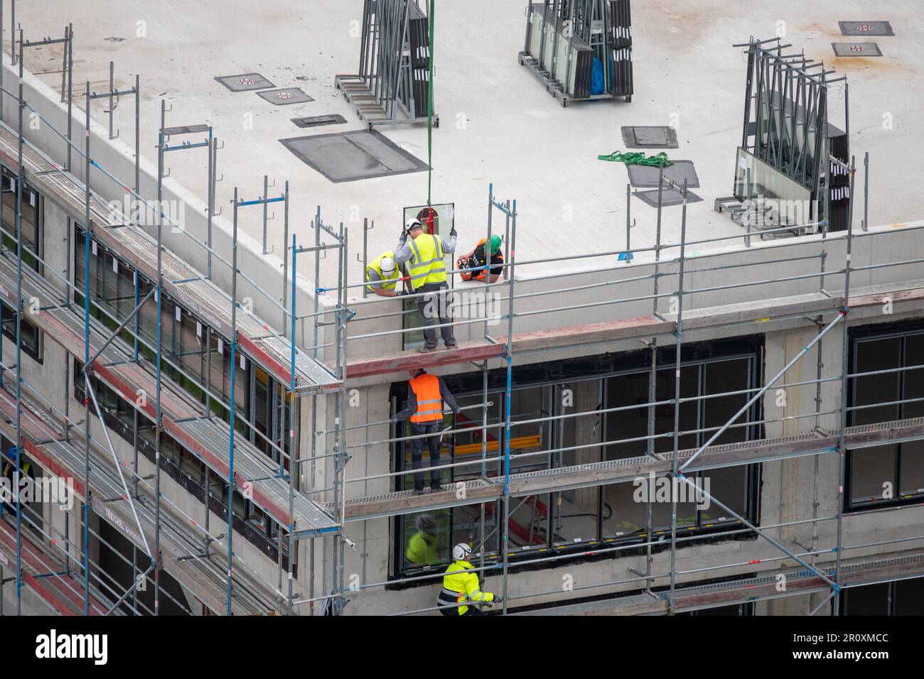 Glazier installing windows on a commercial building Stock Photo - Alamy
