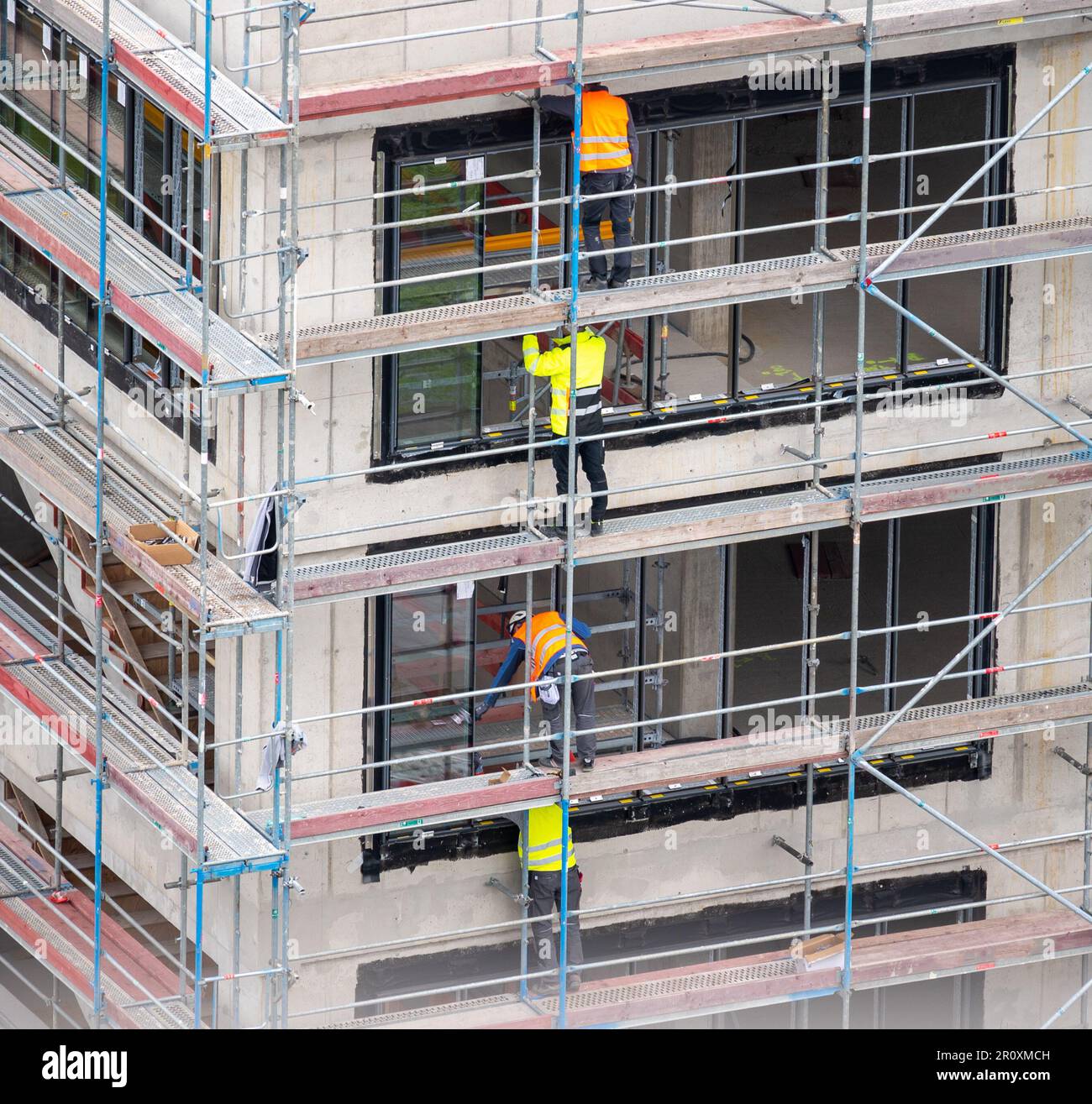 Glazier installing windows on a commercial building Stock Photo - Alamy