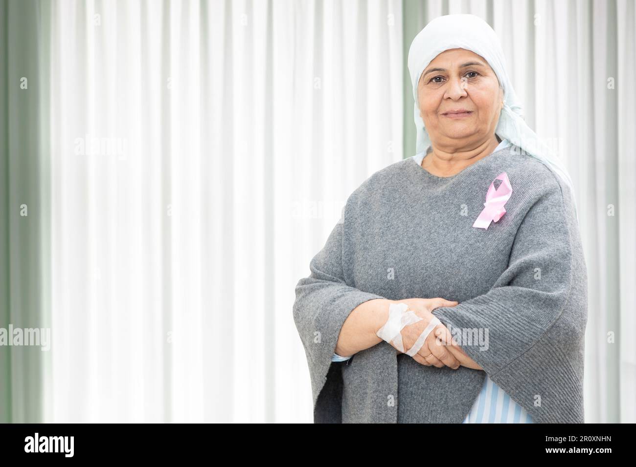 Portrait of indian senior woman cancer patient standing cross arms at ...