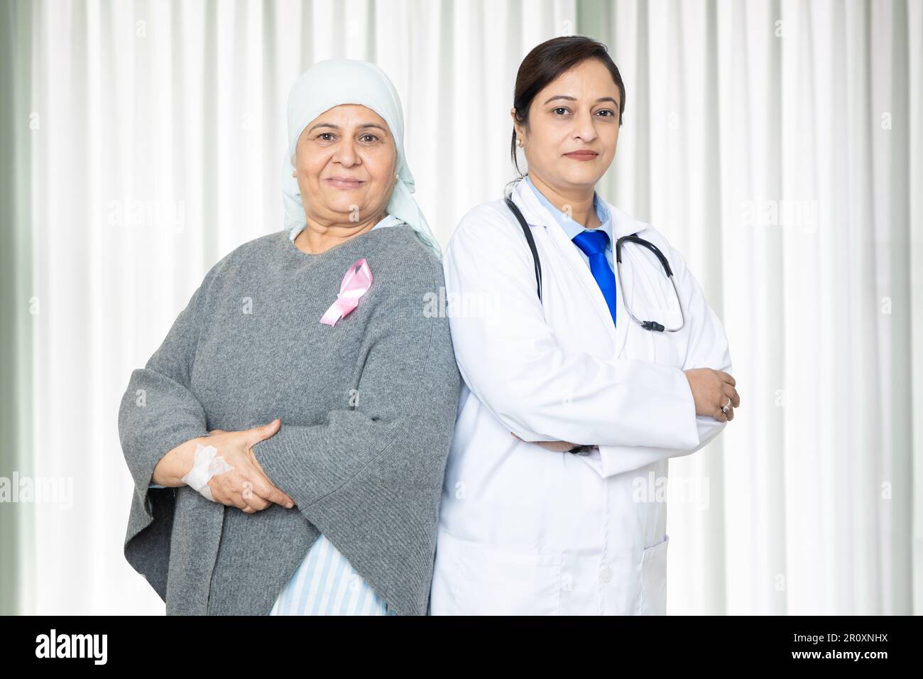 Portrait of indian senior woman cancer patient and doctor do standing ...
