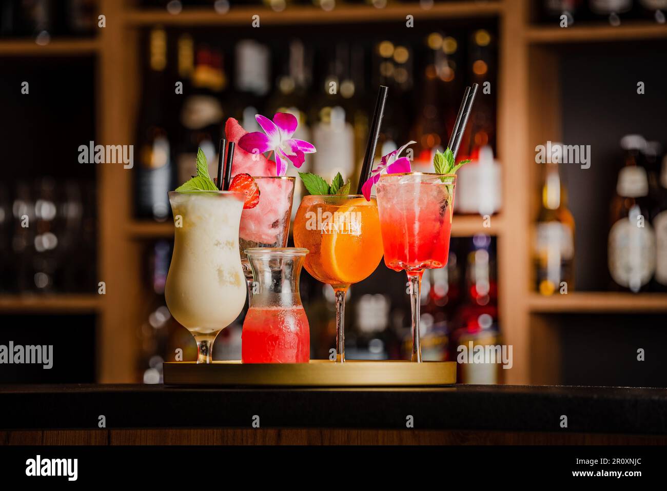 A vibrant image of a variety of drinks lined up on a bar counter Stock ...