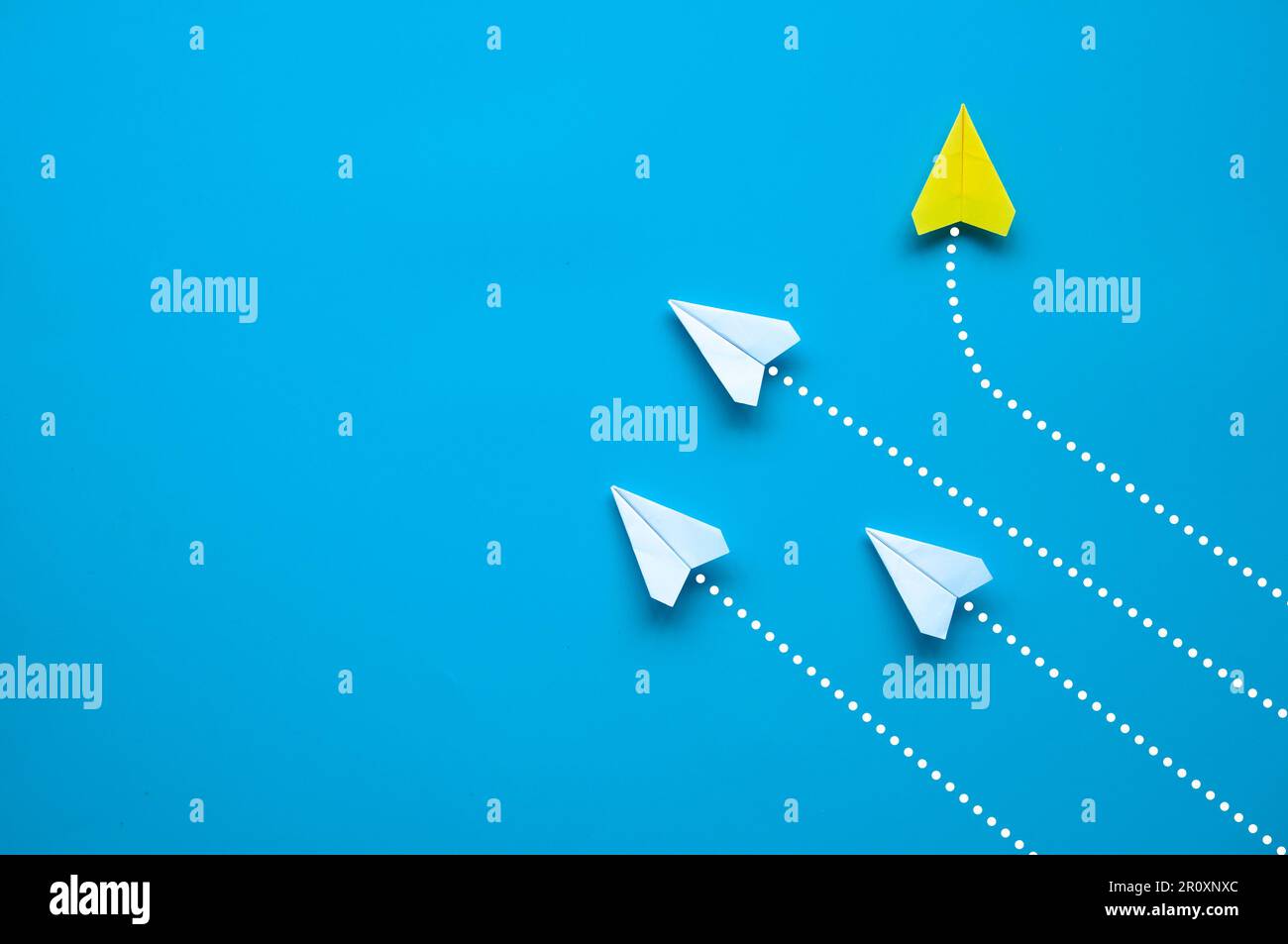 Top view of paper airplane - Yellow paper airplane origami flying to a ...