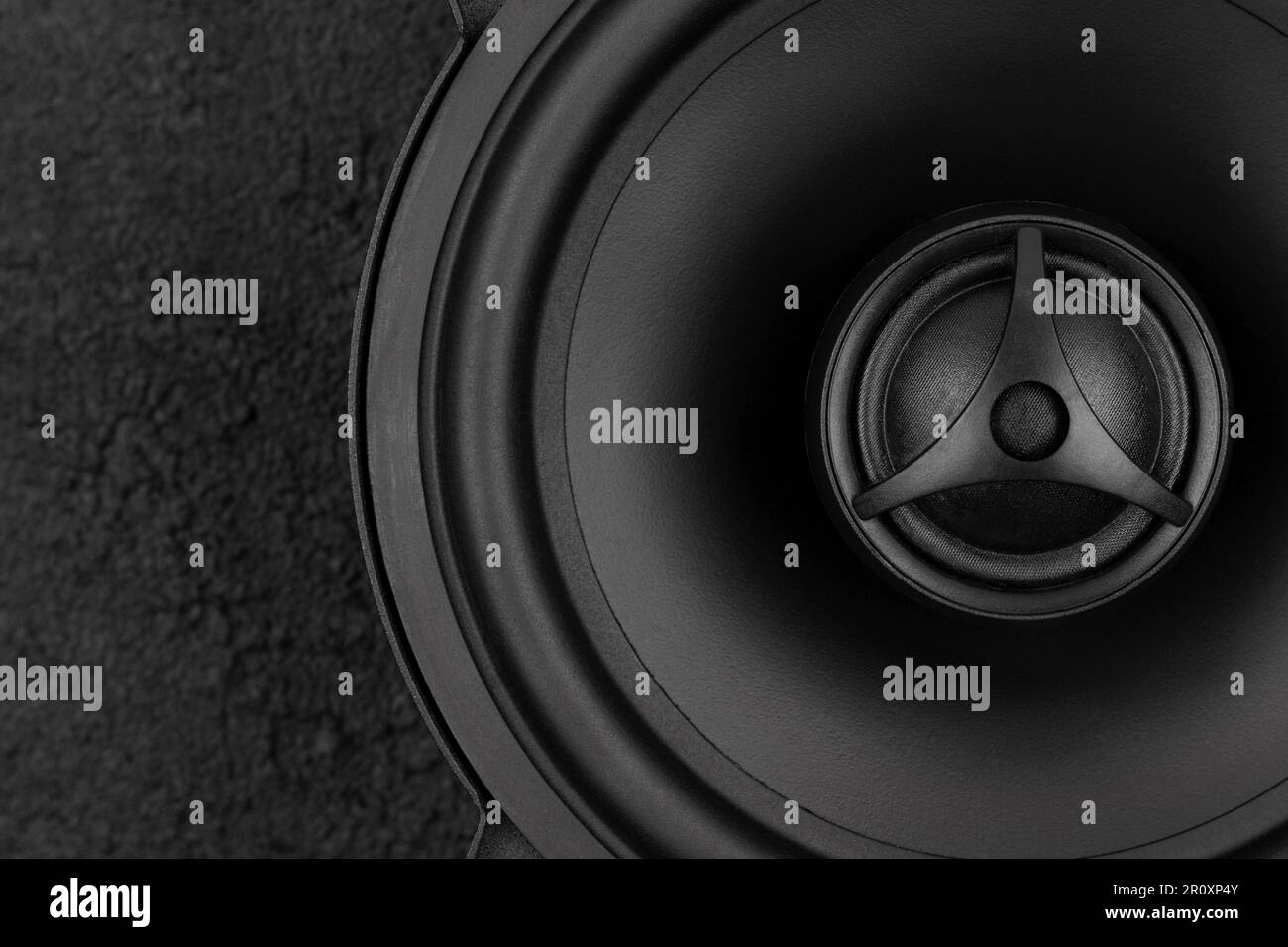 Stylish car audio acoustic round speaker on dark black background, top ...