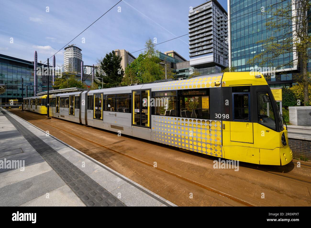 Manchester Metrolink tram waiting at a tram stop in Greater Manchester ...