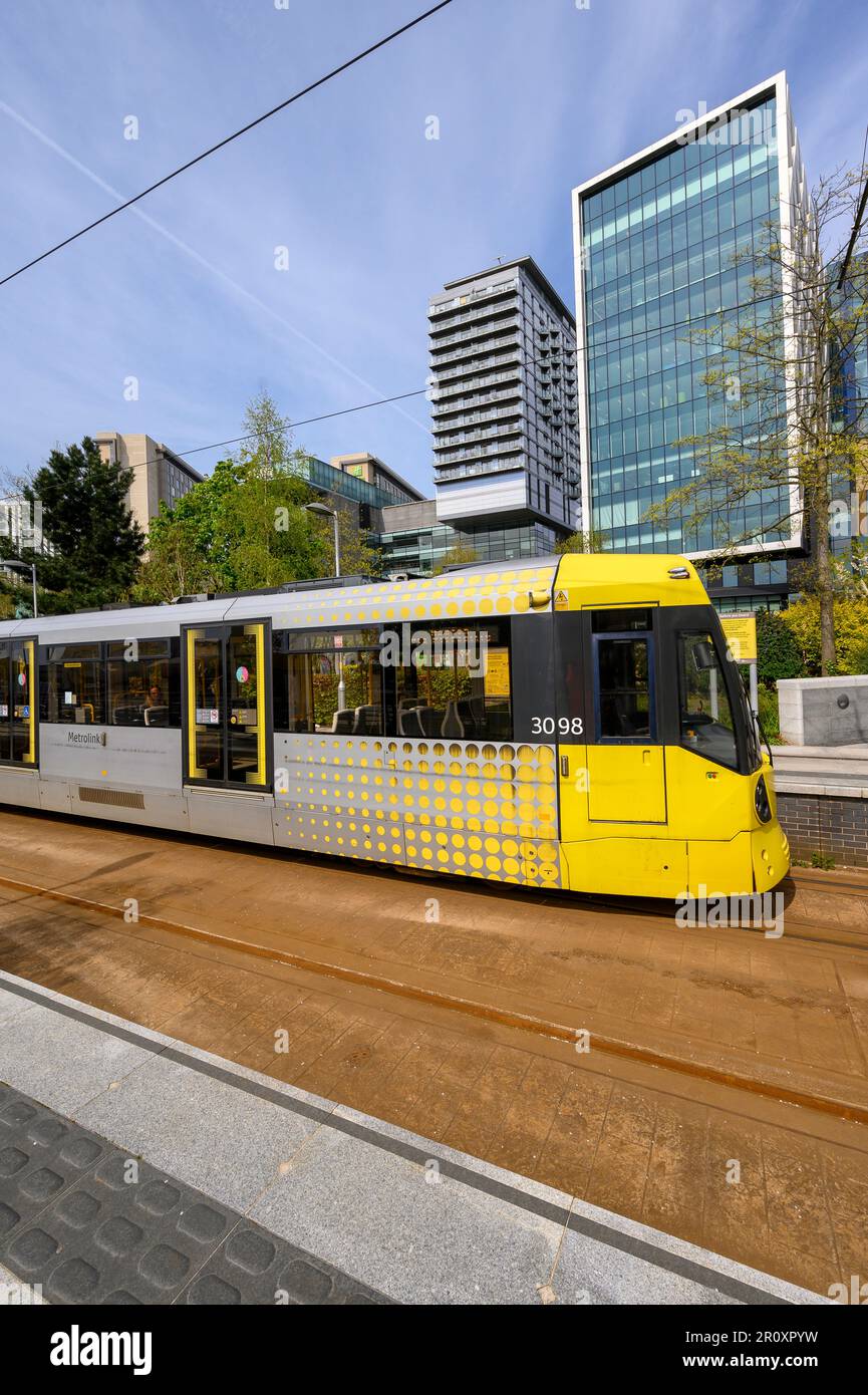 Manchester Metrolink tram waiting at a tram stop in Greater Manchester ...