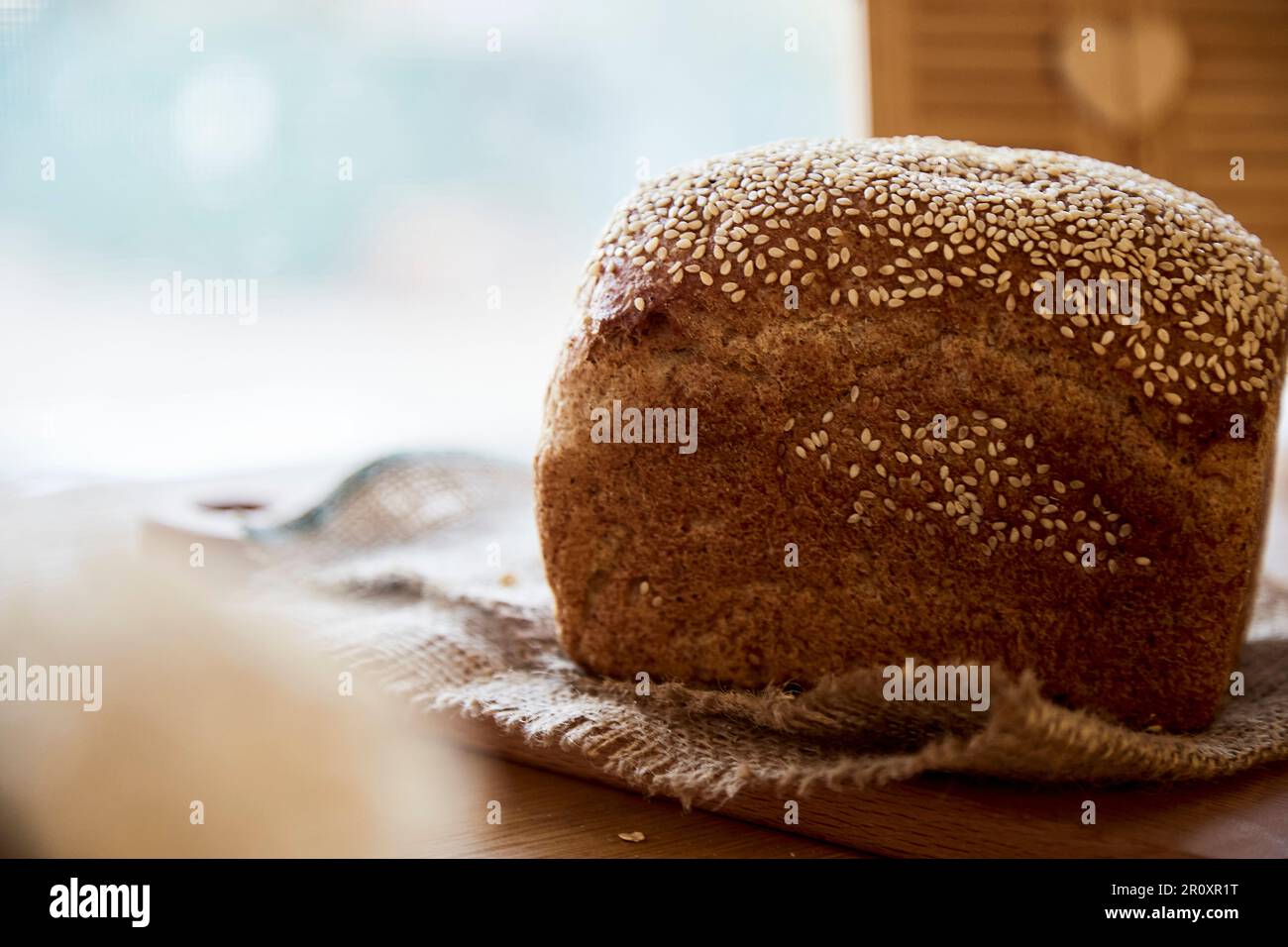 Freshly baked natural sourdough unleavened bread on rustic sackling ...
