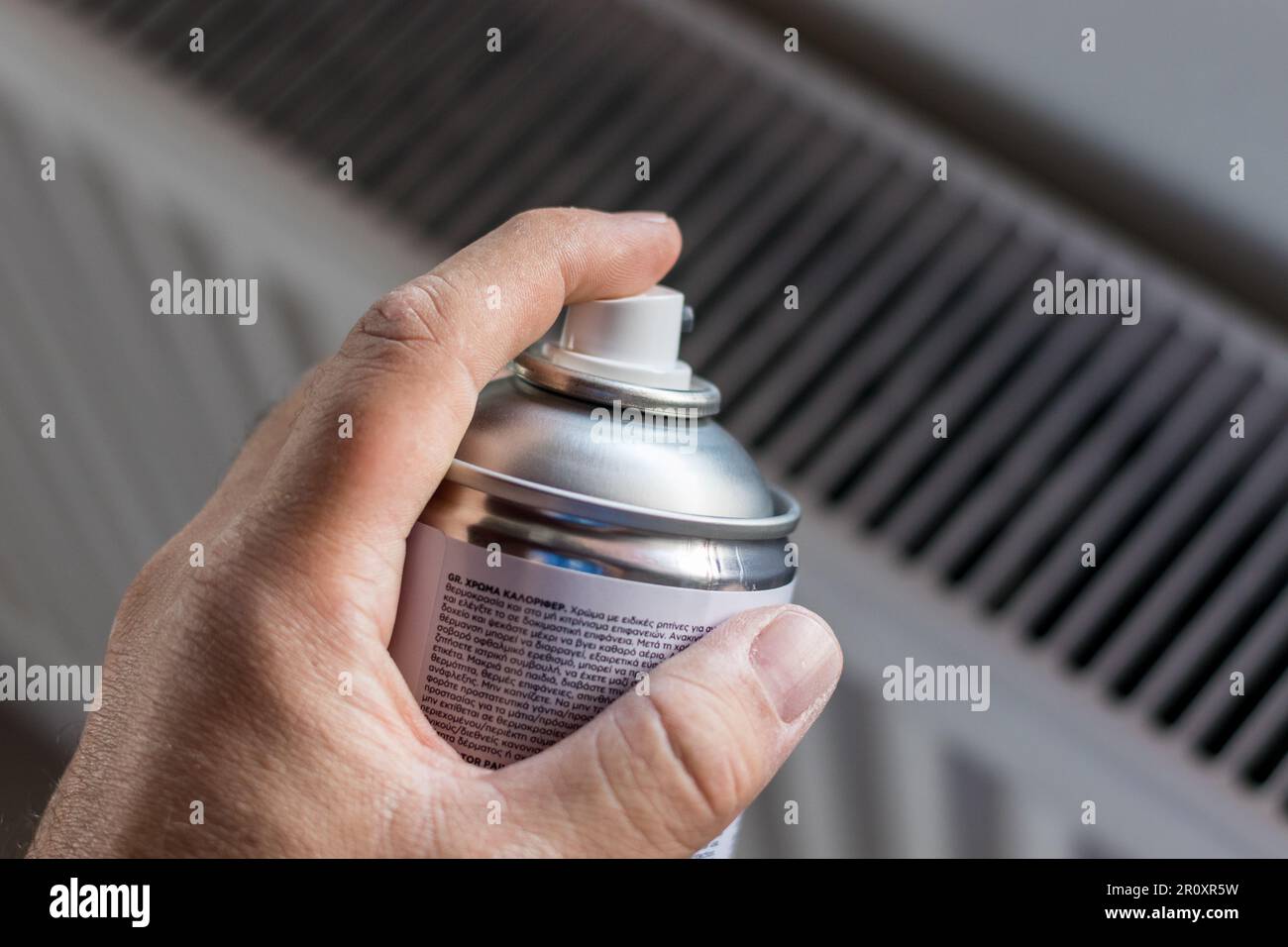 Paint a Heating radiator with spray Stock Photo - Alamy