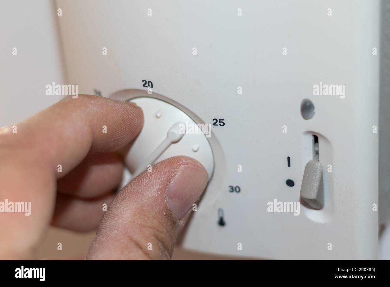 Central Heating thermostat control dial adjustment Stock Photo - Alamy