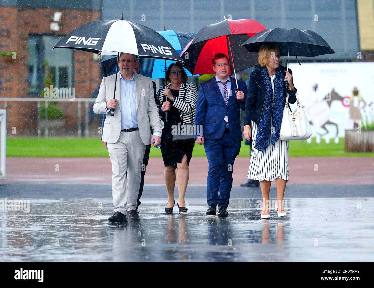 Racegoers shelter from the rain during the Boodles May Festival City ...