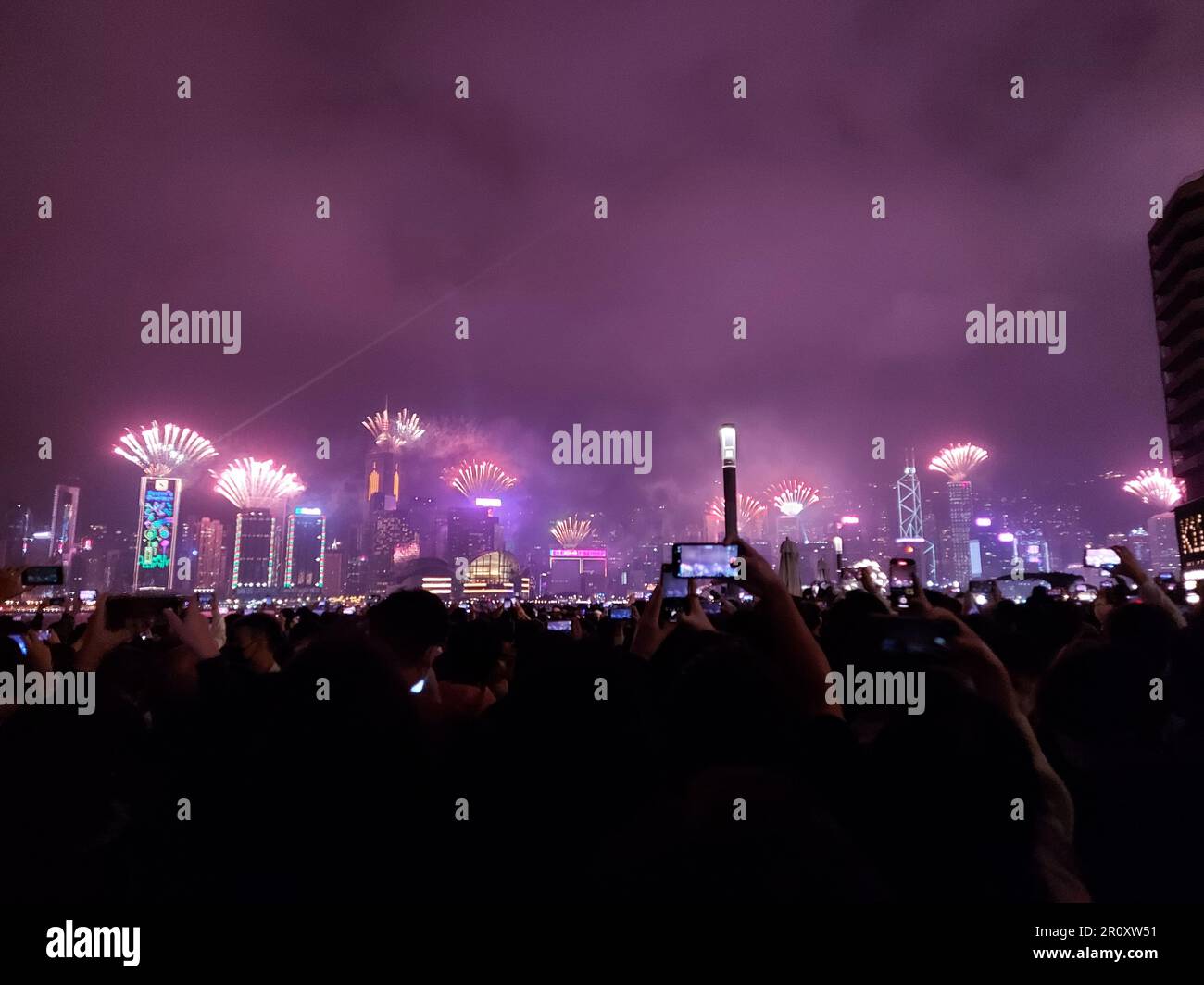 Crowd of diverse people enjoying an impressive display of fireworks in ...