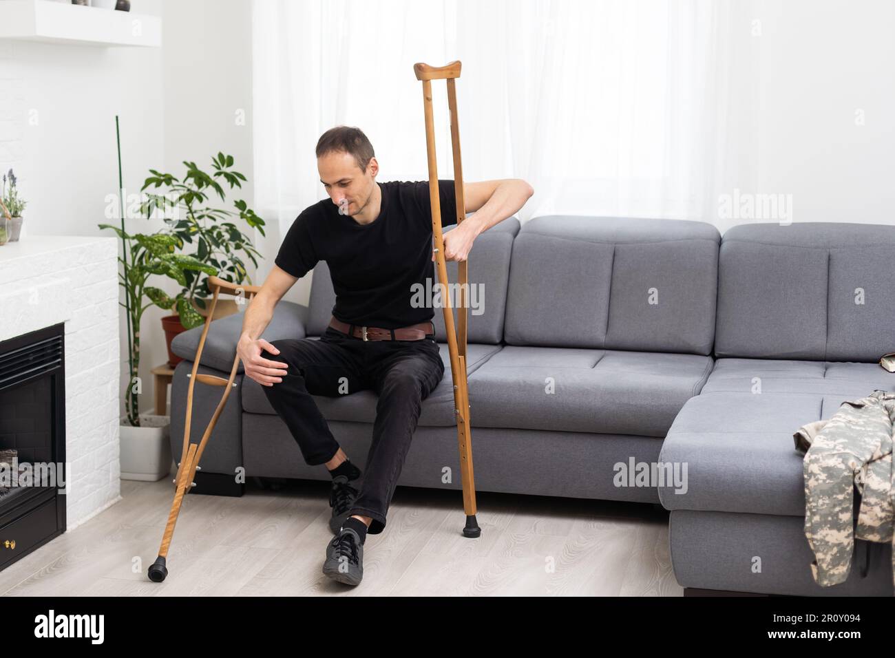 Disabled Man Using Crutches At Home Stock Photo - Alamy