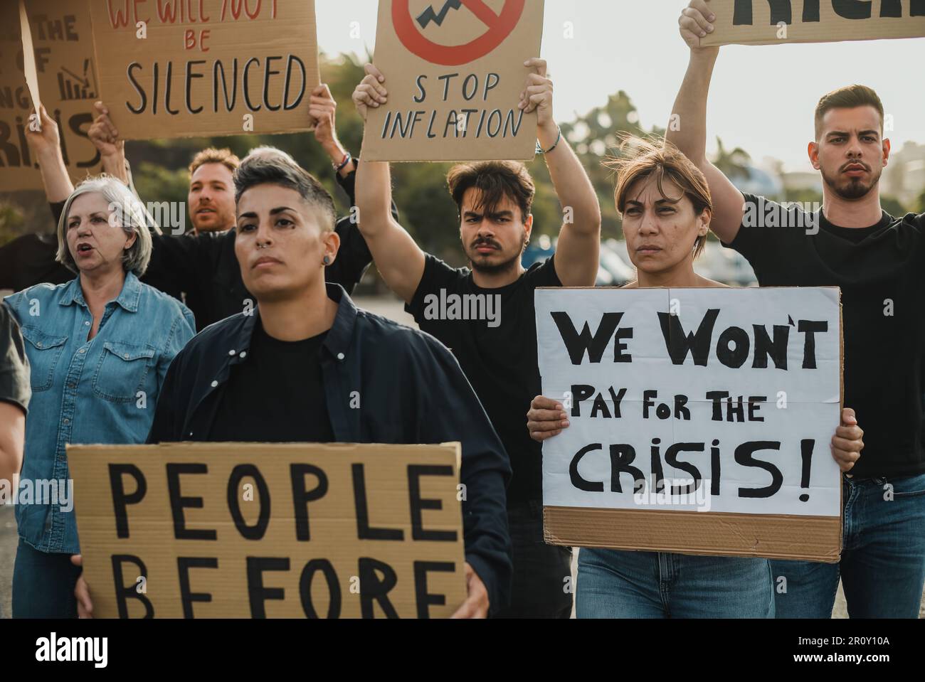 Group of determined fighters for ecology holding carton placards with ...