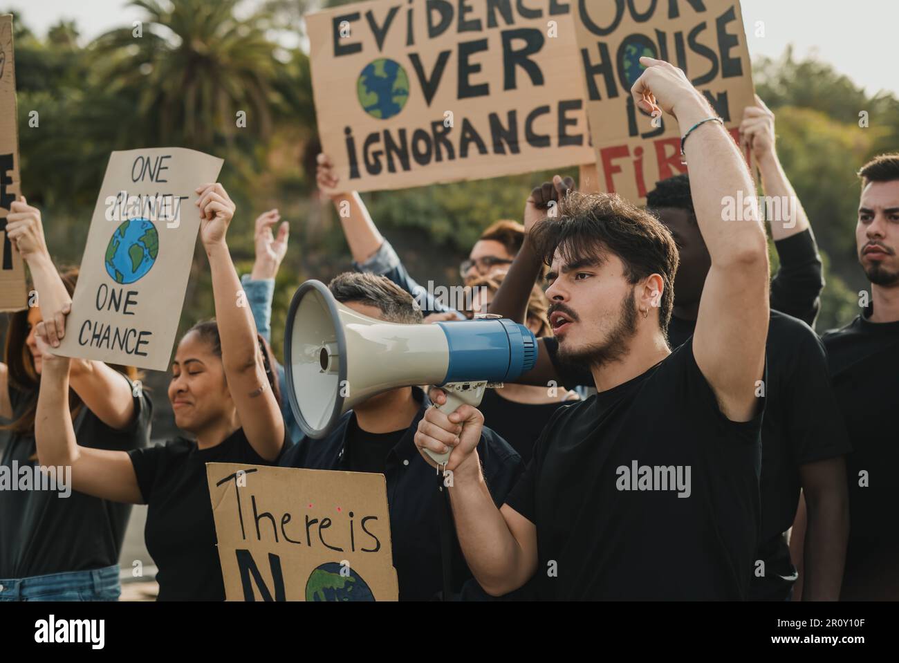 Group of diverse protesters with placards with globe illustrations and ...