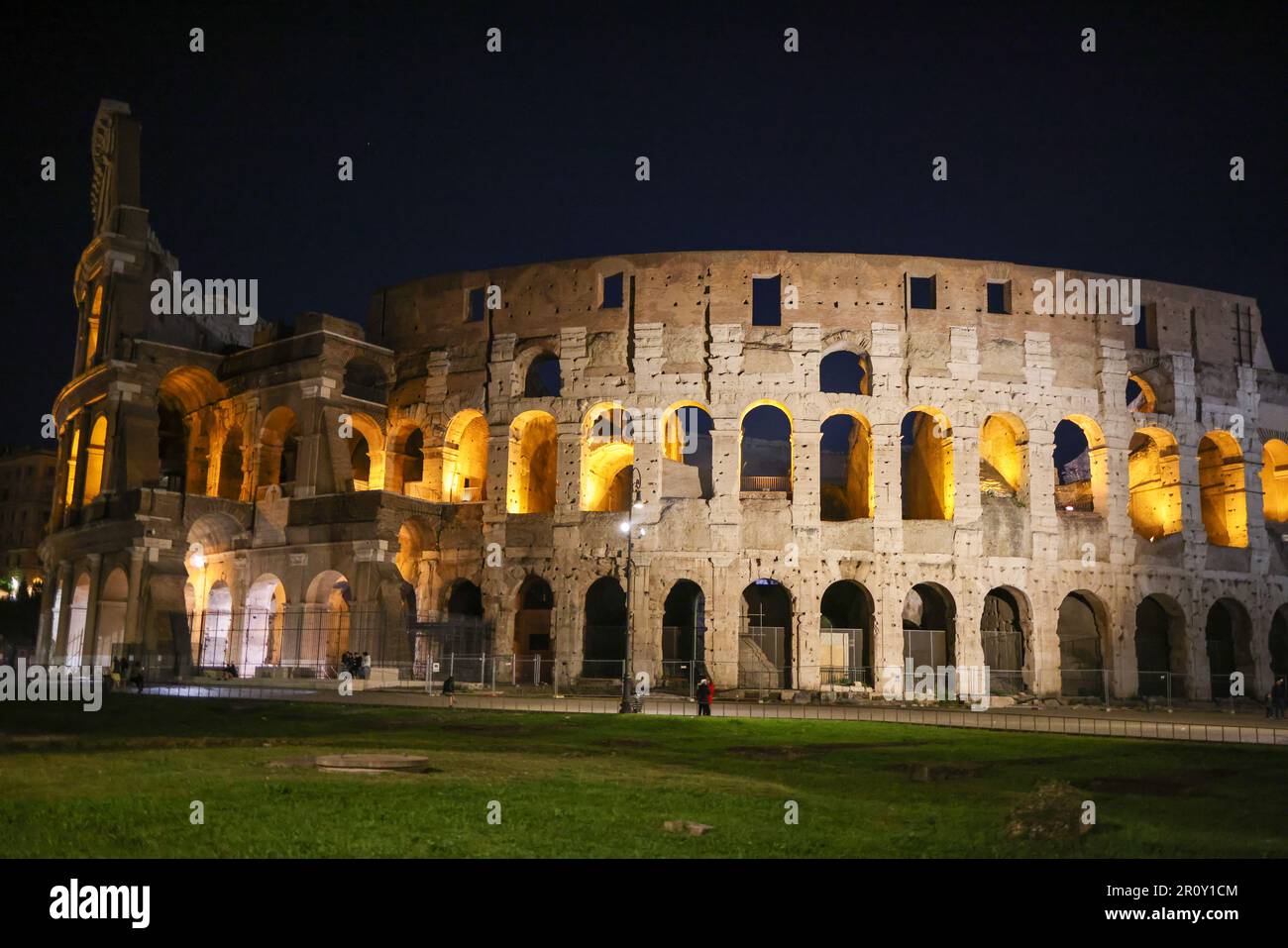 The iconic Coliseum of Rome, Italy illuminated by the lights at night ...