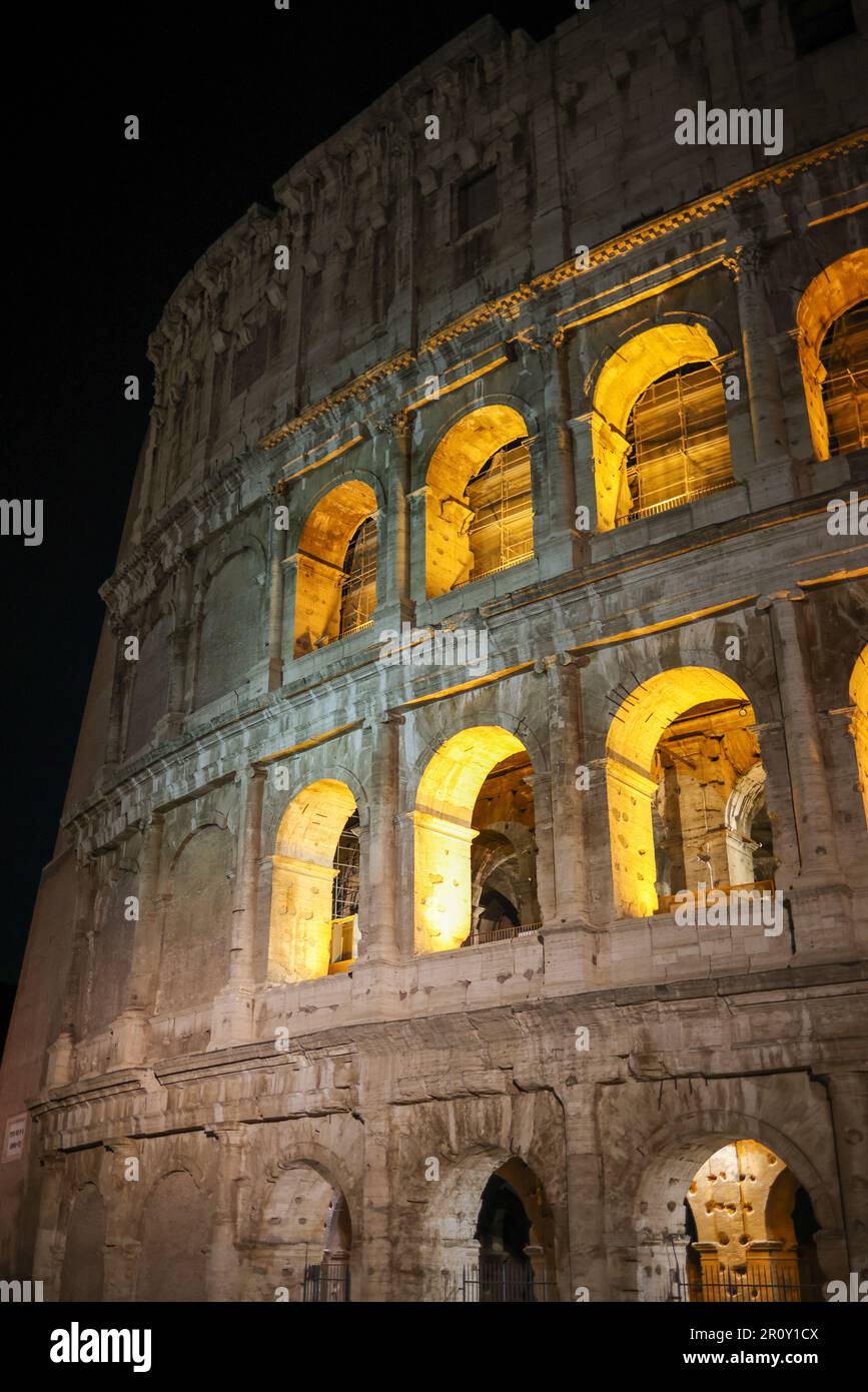 The iconic Coliseum of Rome, Italy illuminated by the lights at night ...