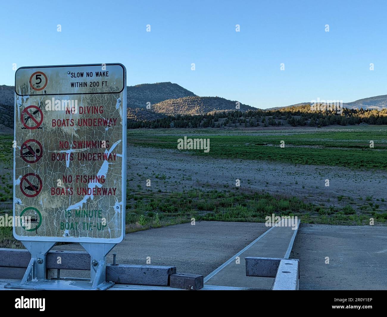 A rustic warning sign with a breathtaking landscape in the background ...