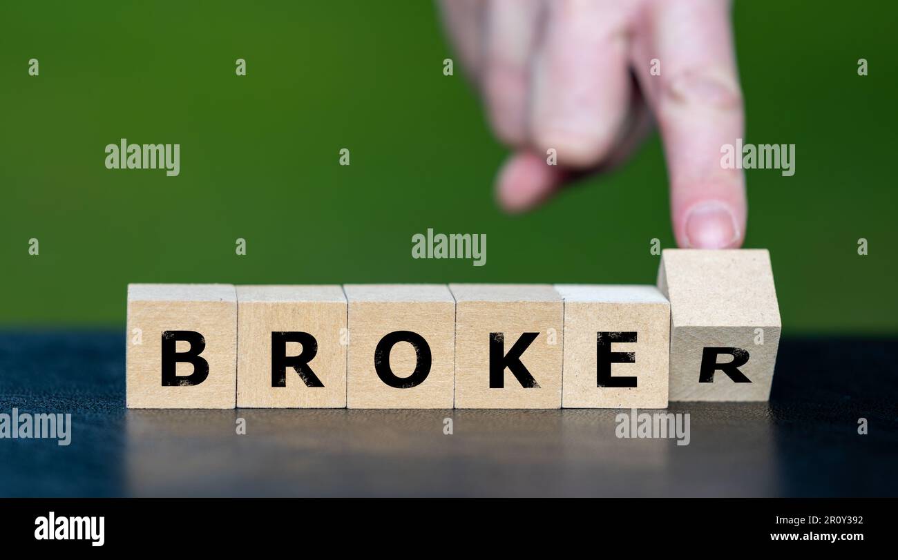 Hand turns wooden cube and changes the word broker to broke. Symbol for ...