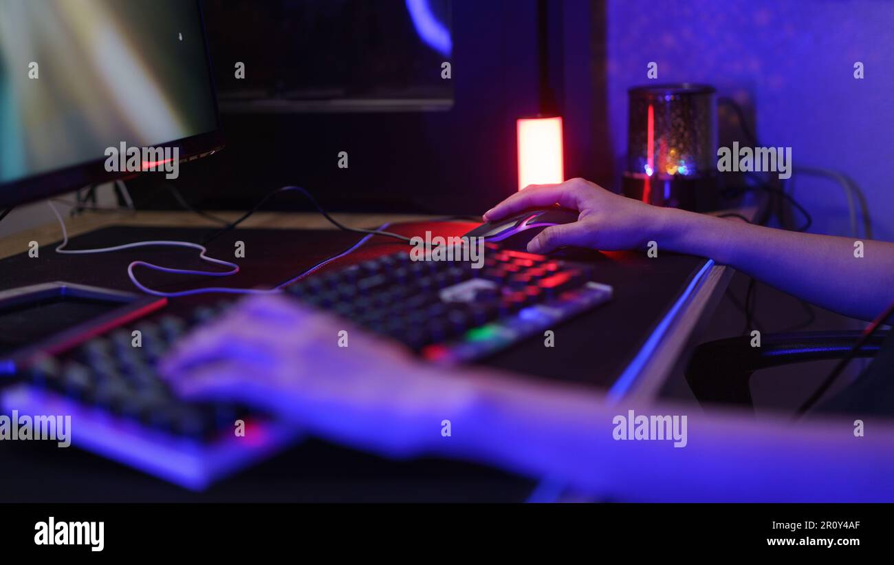 Hand of female cyber hacker gamer on keyboard to playing games or ...