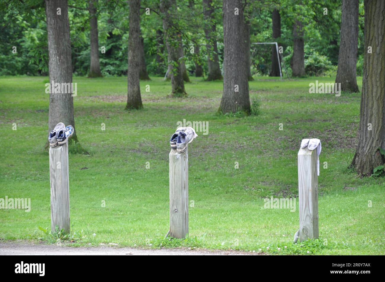 Shoes and socks drying on a wood pillars Stock Photo - Alamy