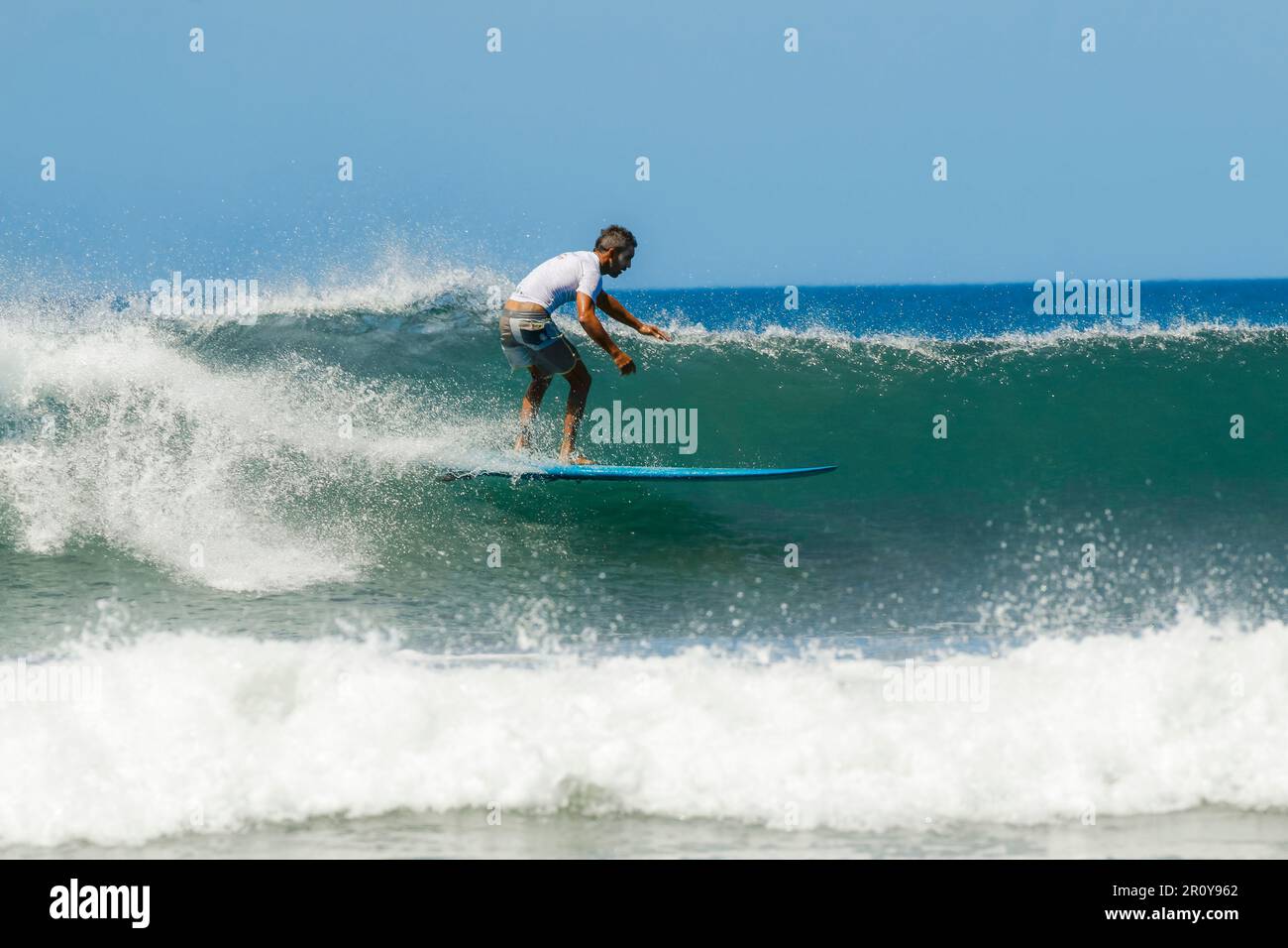 Longboard surfer rides the face of a wave at this fast-growing surf ...