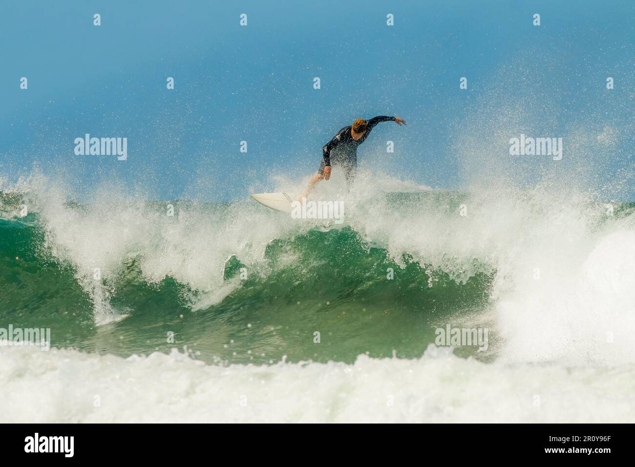 Shortboard surfer does a 'floater' on the back of a wave at this surf ...