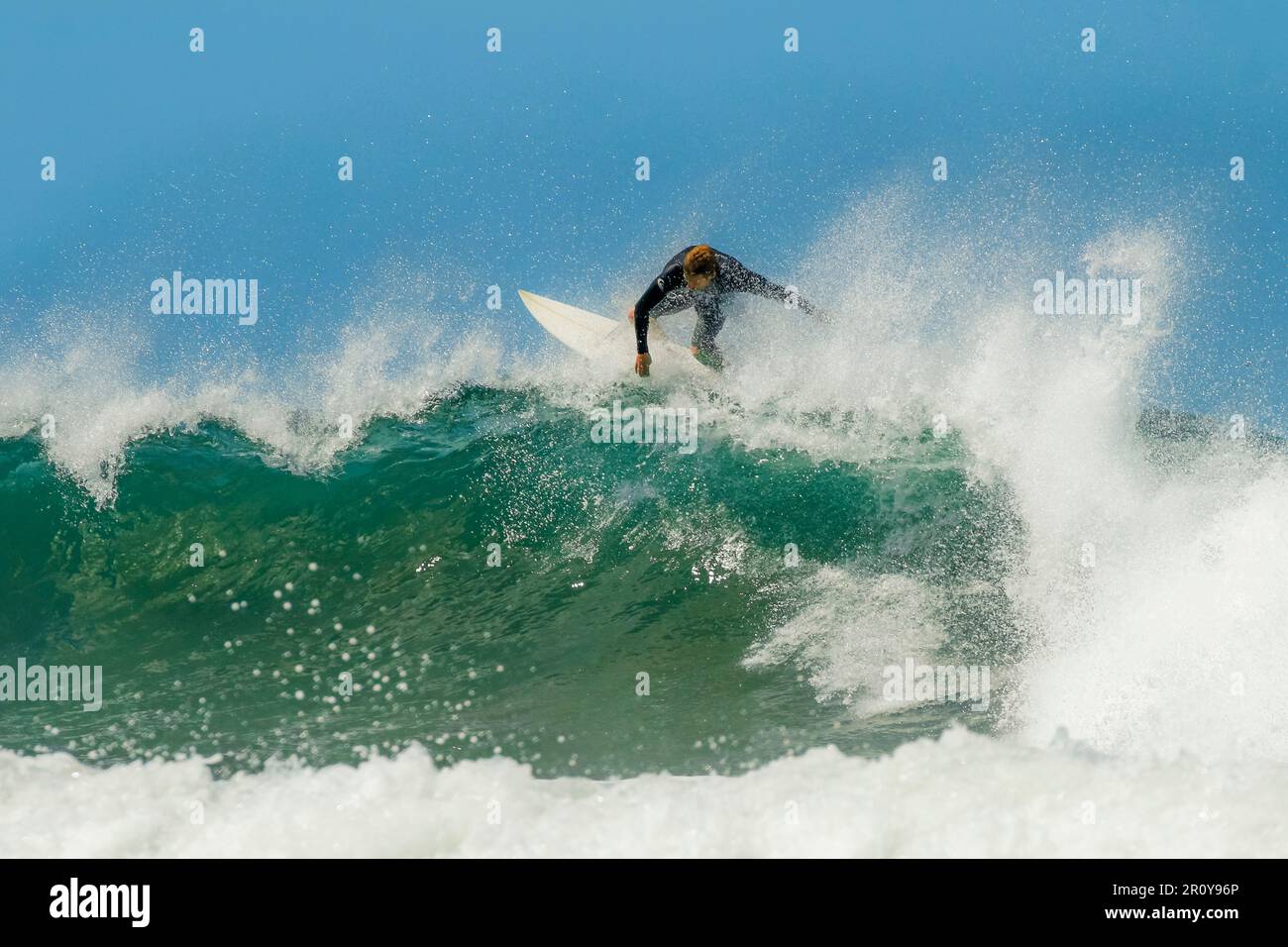 Shortboard surfer turns on the crest of an overhead wave at this surf ...