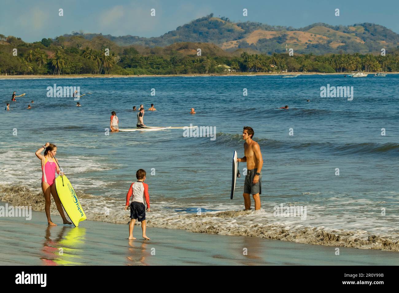 Beach goers enjoy this popular palm-fringed white sand bay at this laid ...