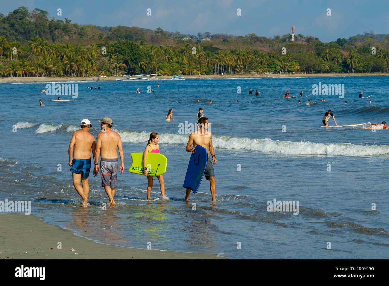 Beach goers enjoy this popular palm-fringed white sand bay at this laid ...