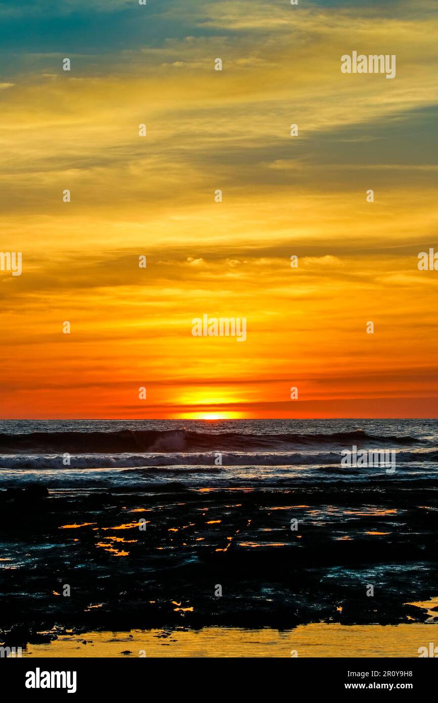 Sunset reflected over intertidal rocks & pools at the popular Guiones ...