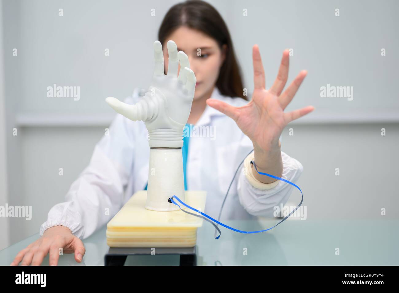 Technician testing robotic bionic arm at prosthetic manufacturing Stock ...