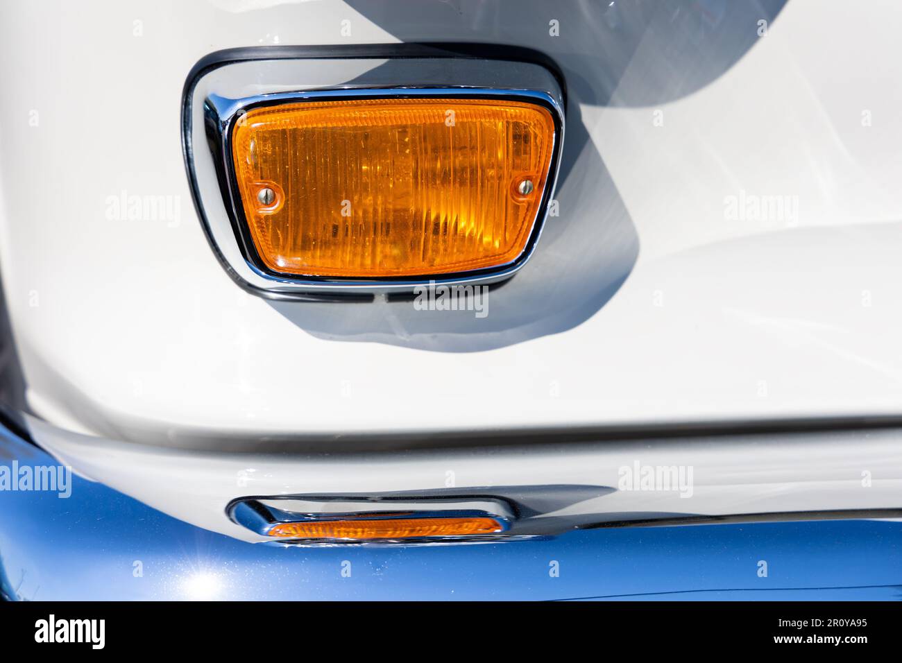 Close-up of the round turn indicator lights of a white classic car ...