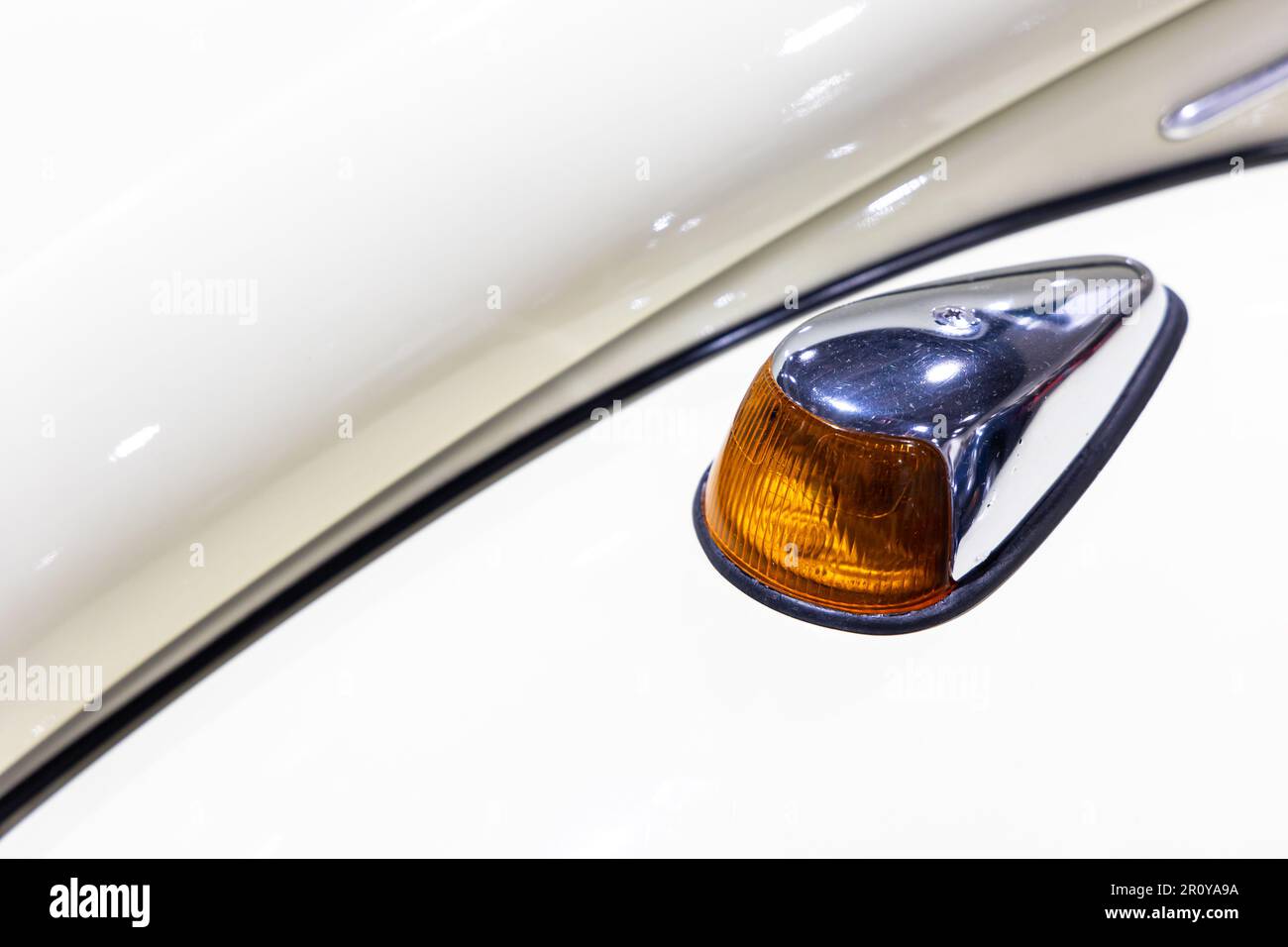 Close-up of the round turn indicator lights of a white classic car ...