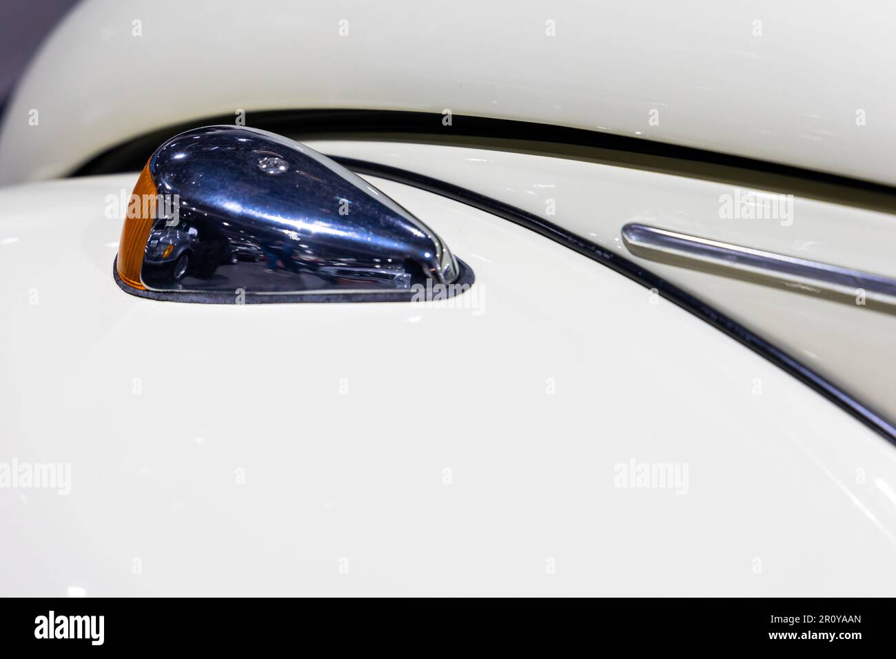 Close-up of the round turn indicator lights of a white classic car ...