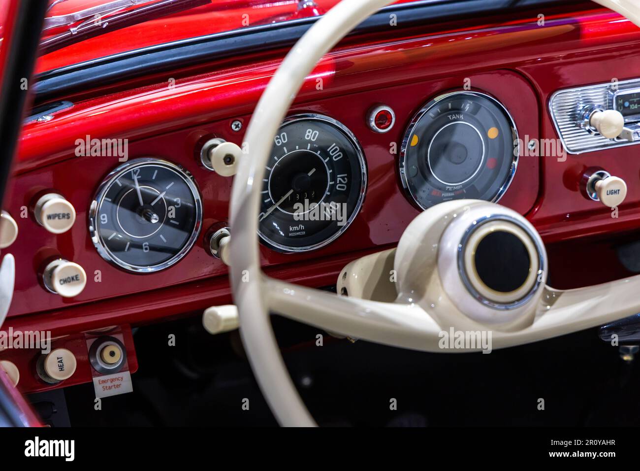 Dashboard of a stylish red classic car. The excellent restoration of ...