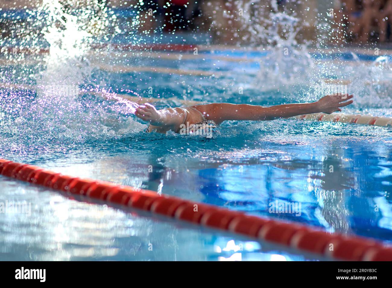 a swimmer waves his arms in the water while performing a butterfly at a ...