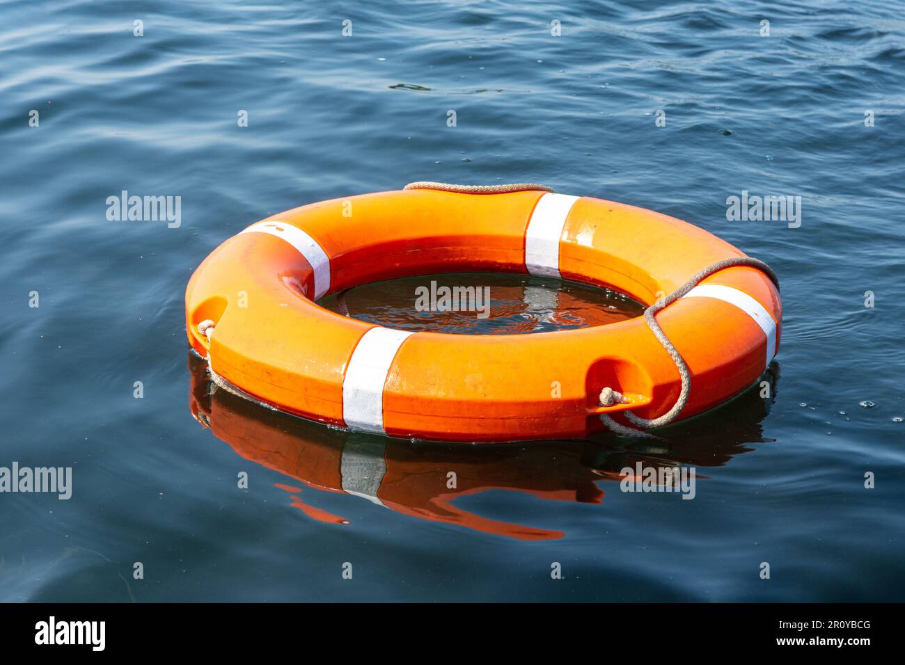 Lifebuoy in the blue water of the lake Stock Photo - Alamy