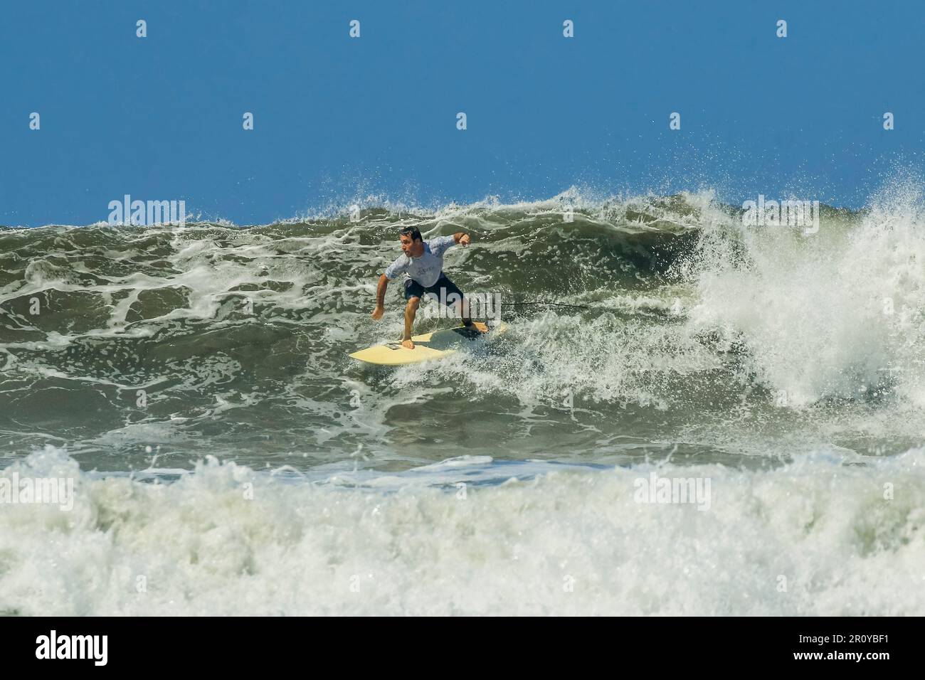 Shortboard surfer rides the face of an overhead wave at this hip surf ...