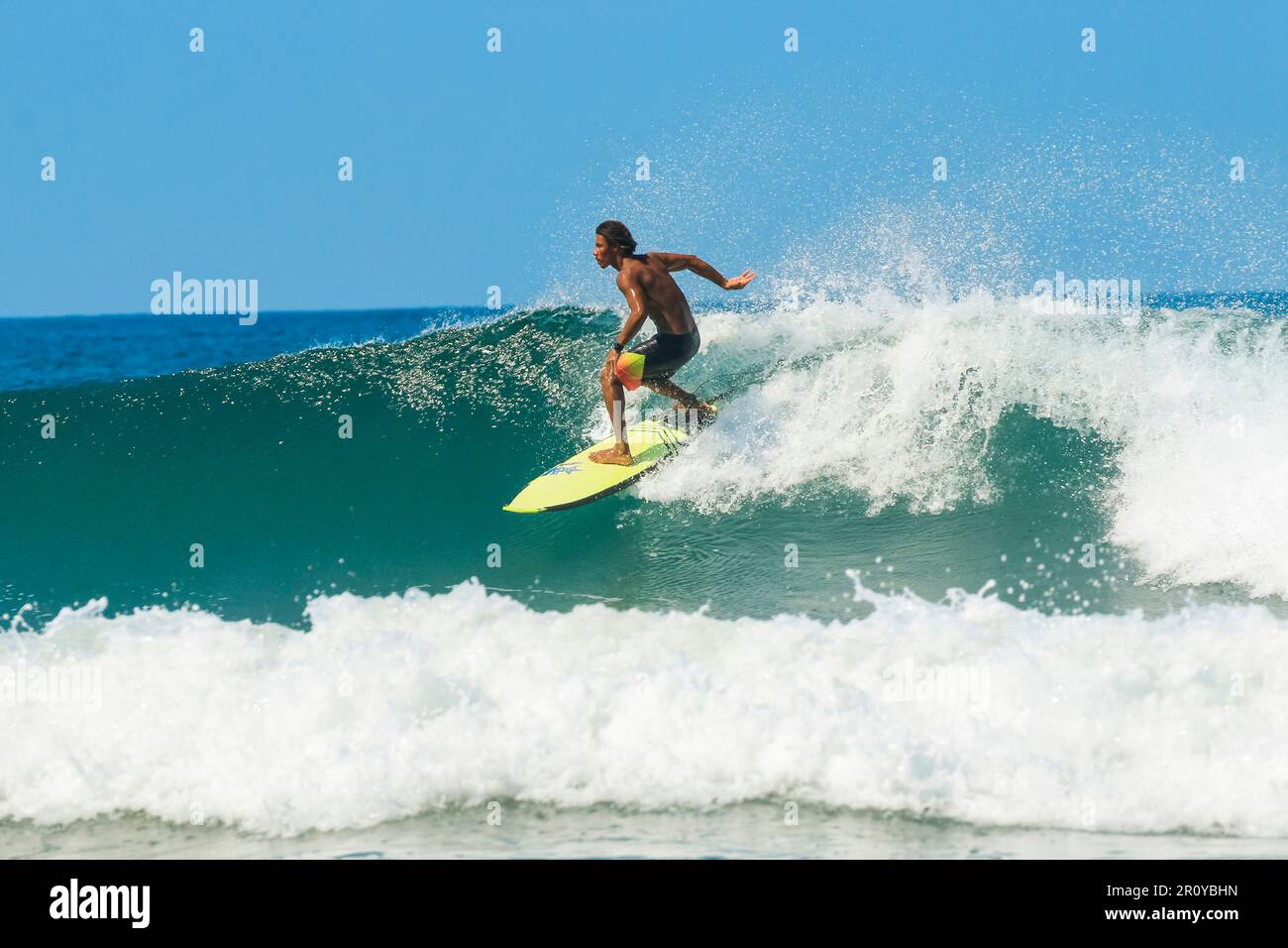 Surfer on the crest of a breaking wave at this fast-growing surf beach ...