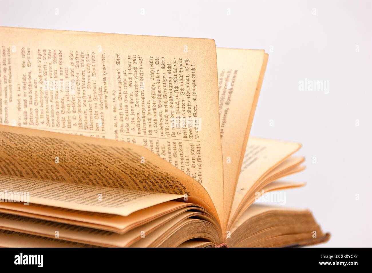 vintage old open book with some visible pages lying on top of other ...