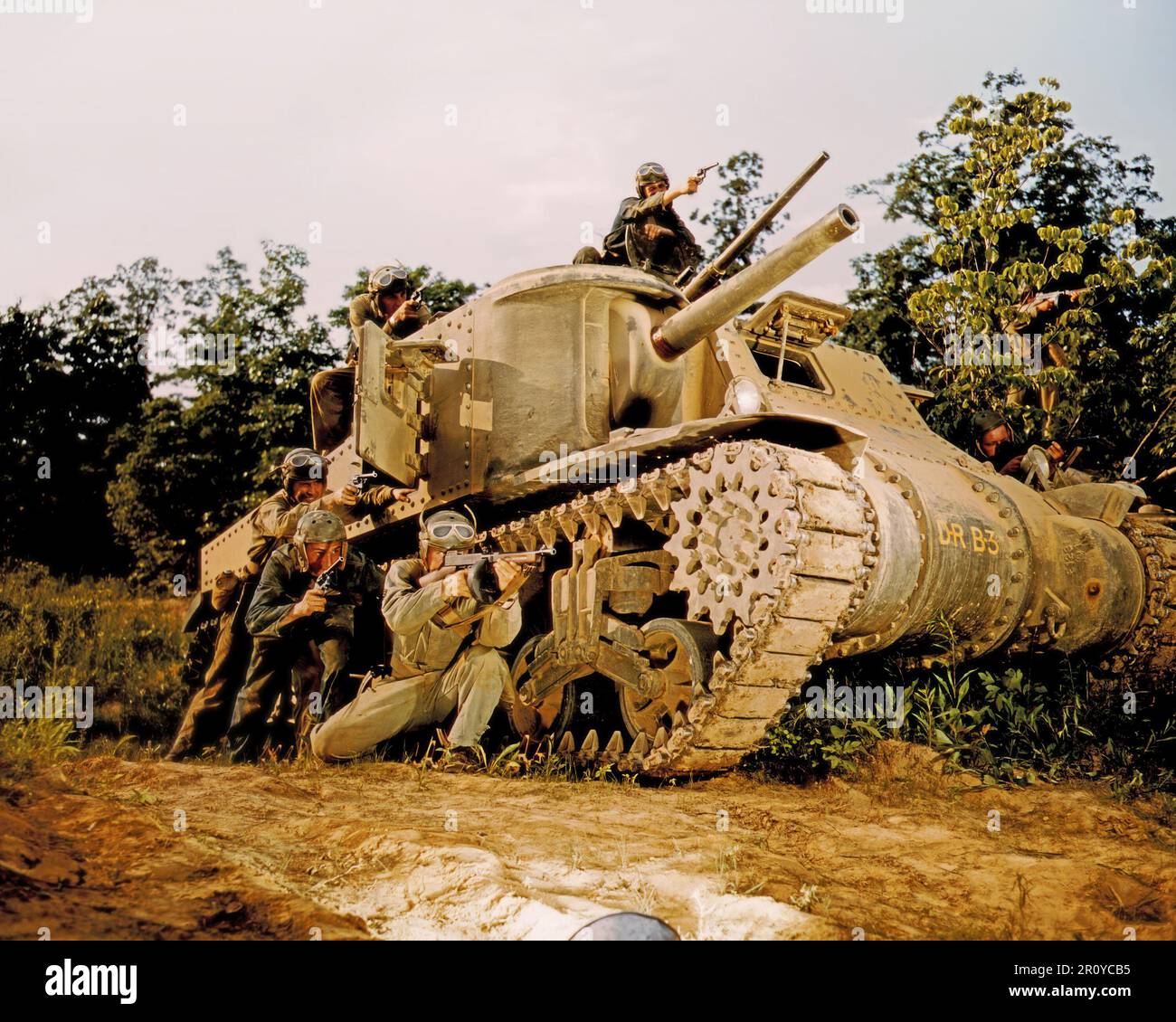 A propaganda photo showing a U.S. Army M-3 tank and crew using small ...