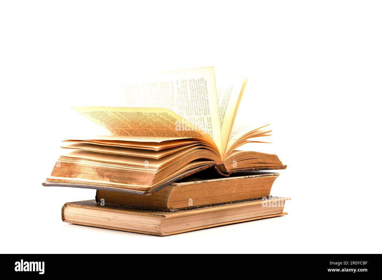 vintage old open book with some visible pages lying on top of other ...