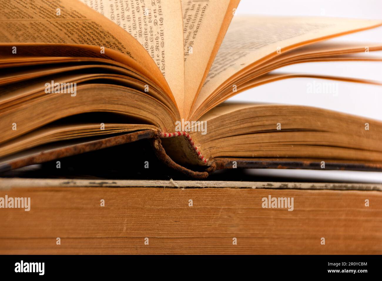vintage old open book with some visible pages lying on top of other ...