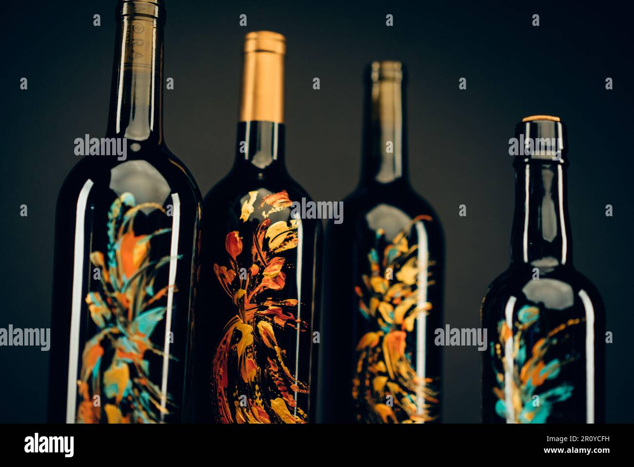 Set of four ceramic bottles in assorted colors and patterns Stock Photo ...