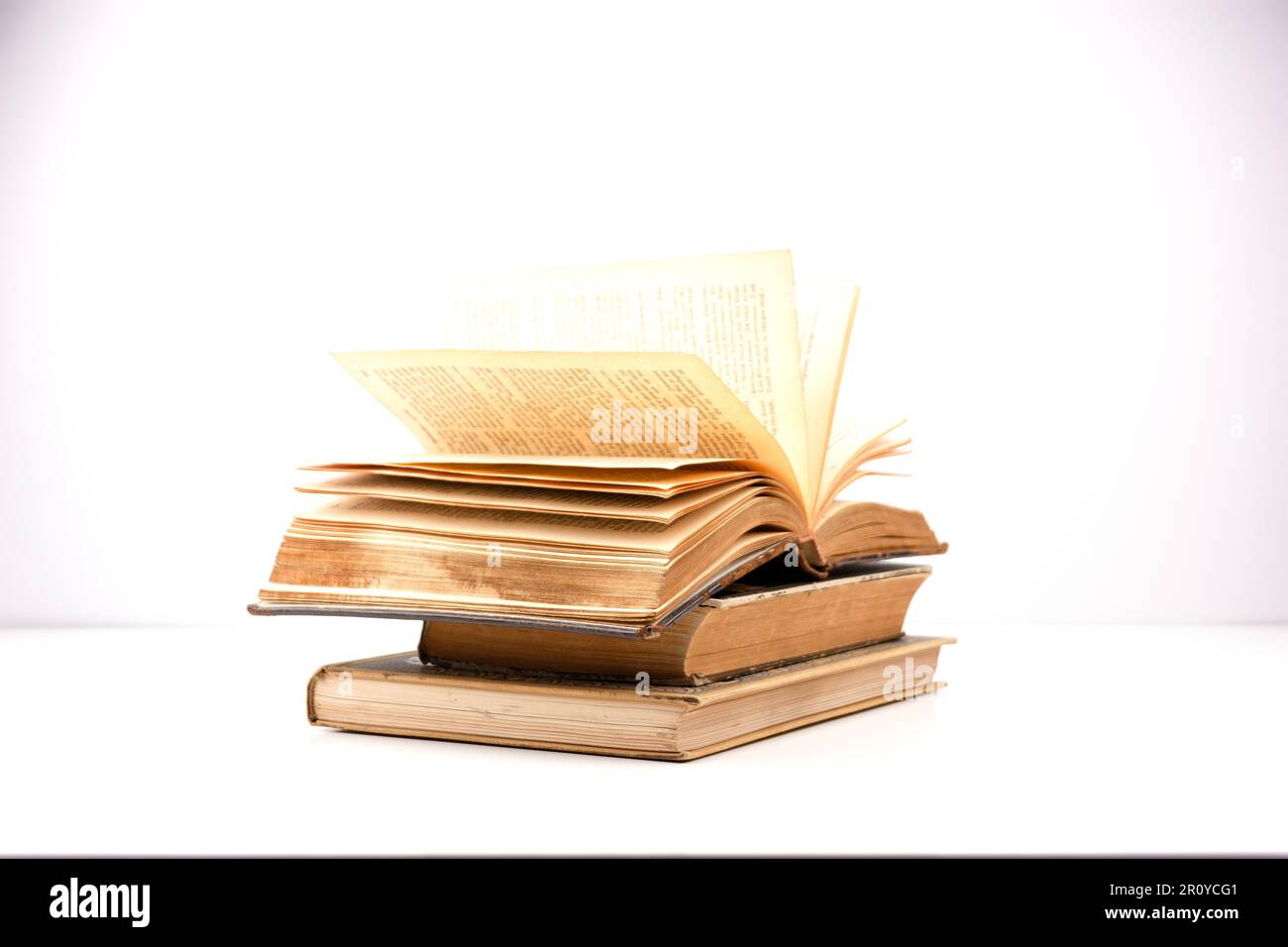 vintage old open book with some visible pages lying on top of other ...