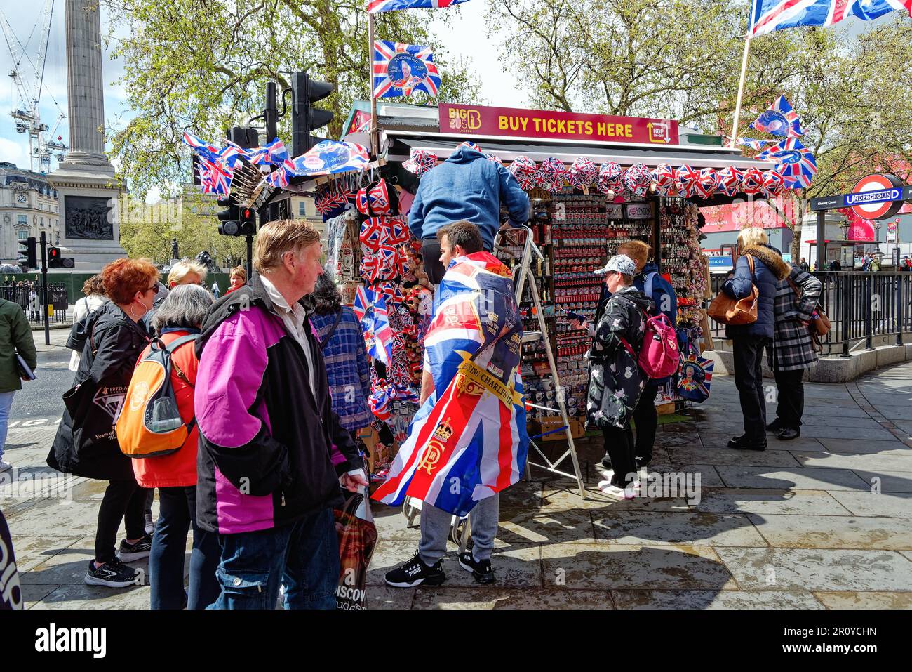 Crowds of tourists looking at a colourful souvenir stall in Trafalgar ...