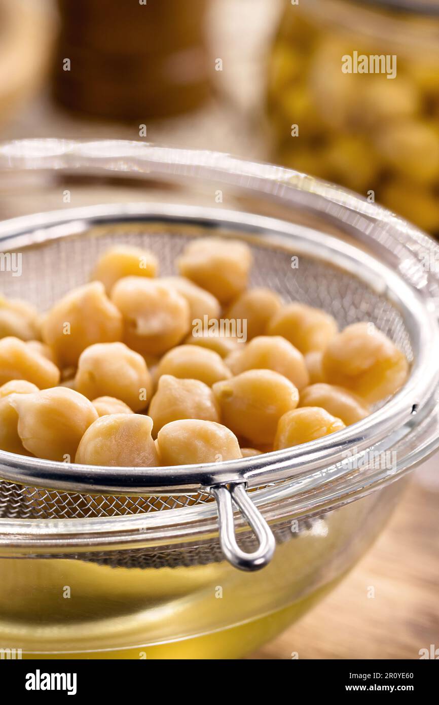 chickpeas being sieved to extract aquafaba, cooking liquid used as an ...