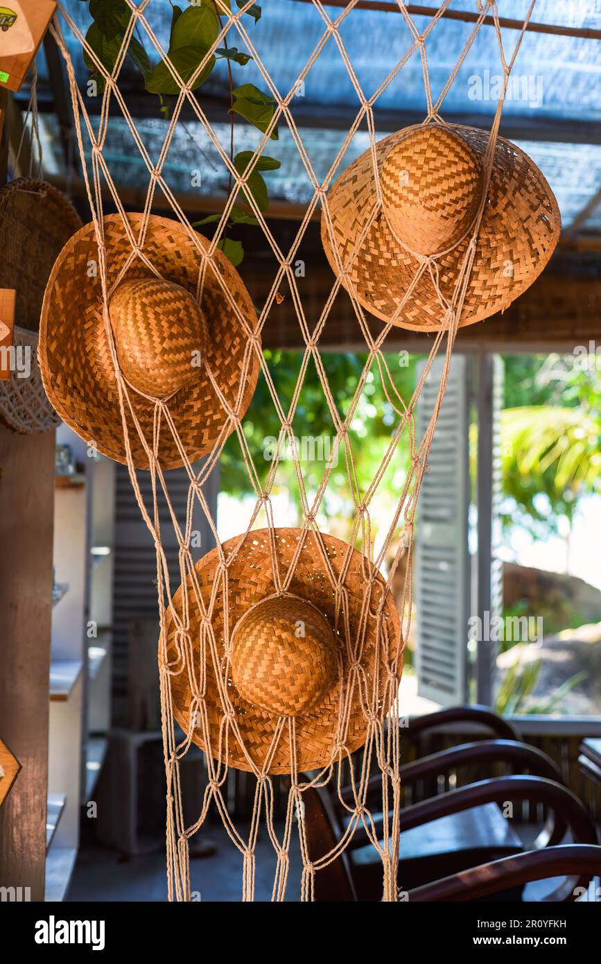 Orange straw hats hanging next to opened windows on a summer day Stock ...